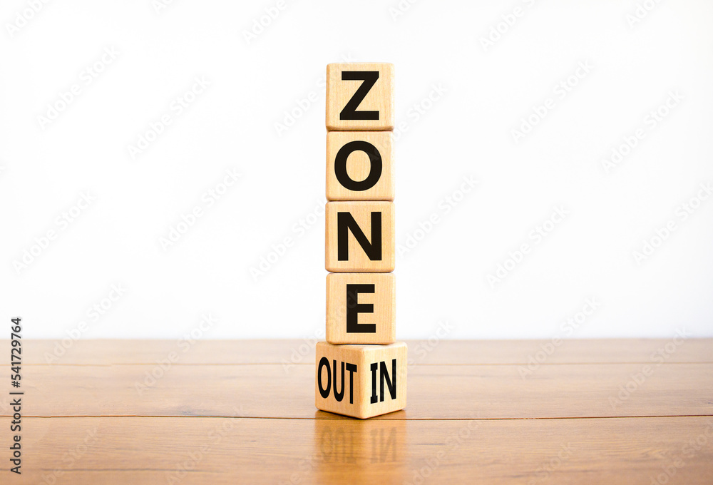Zone in or out symbol. Concept words Zone in and Zone out on wooden ...