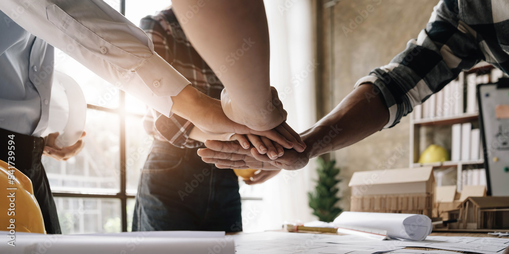 Team of engineer and architects working join hands to build successful ...