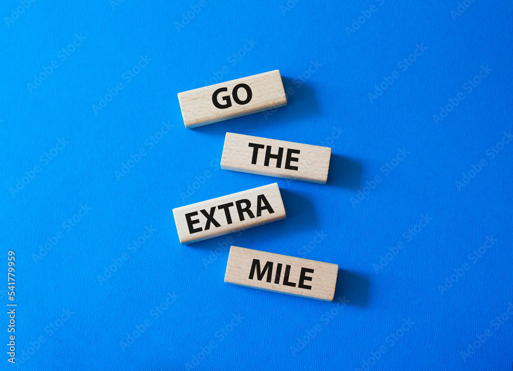 Go the extra mile symbol. Wooden blocks with words Go the extra mile ...