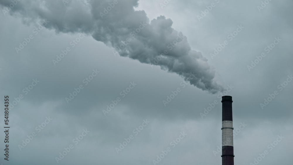 Puffs of hazardous industrial smoke emerge from factory chimney ...