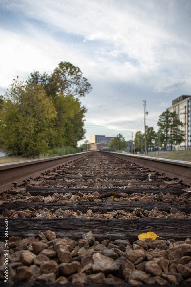 Long Railroad Train Tracks with Buildings and a Pretty Sky in the ...