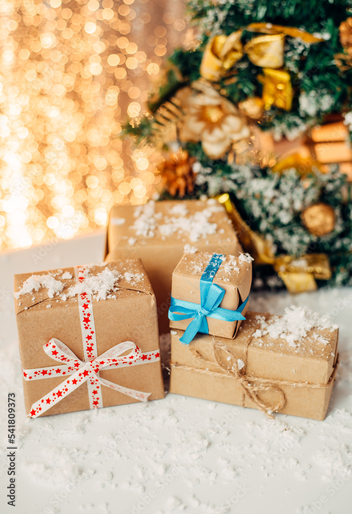 Beautiful Christmas gift boxes on the floor near the Christmas tree in ...
