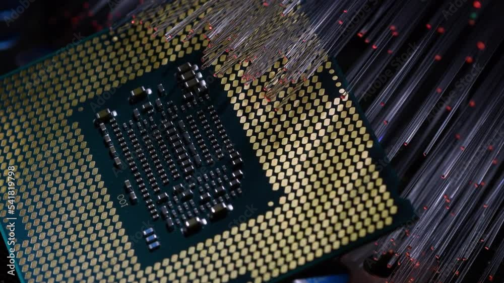 Extreme close up of a modern CPU illuminated by a bunch of colored ...