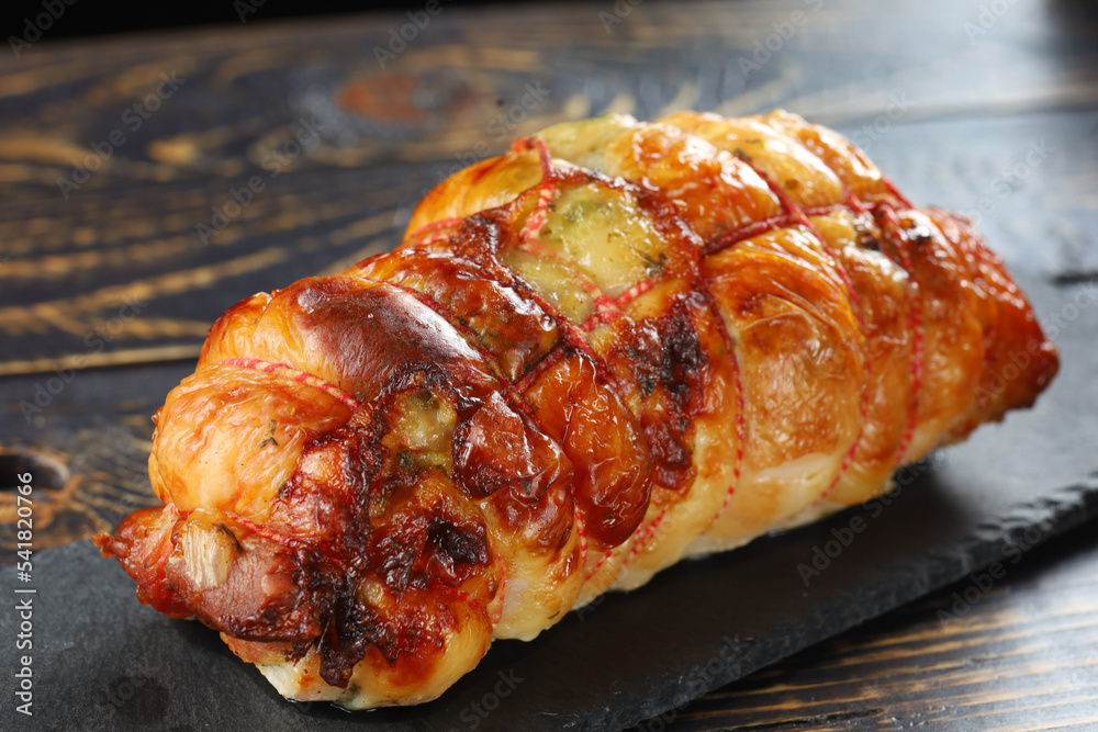 boneless meat roulade on a dark wooden table. Meat roll close-up. Stock ...