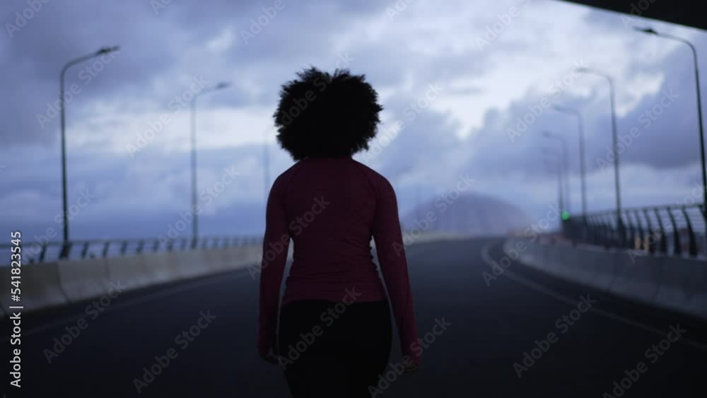 4k Beautiful athletic woman walks on bridge in city during sunset spbas ...