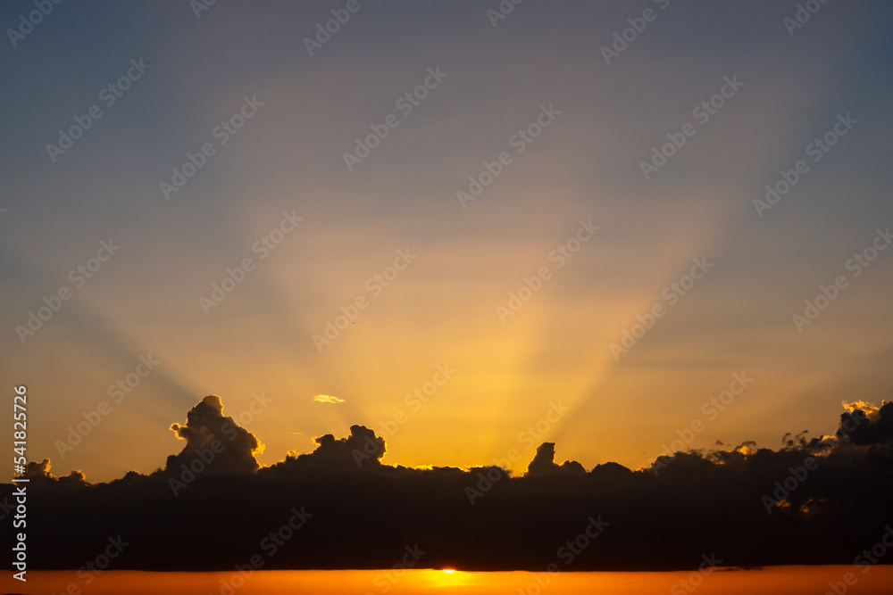 Spectacular sunset with the sun's rays breaking through the clouds ...