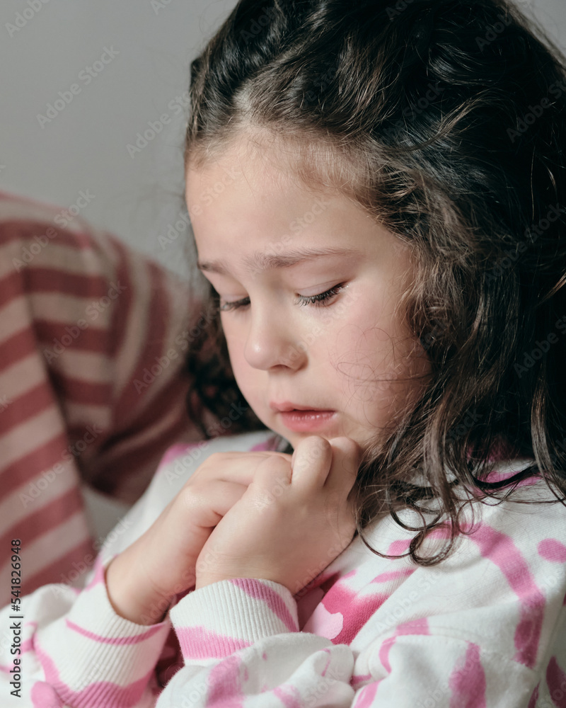 upset little girl being consoled by mom Stock Photo | Adobe Stock