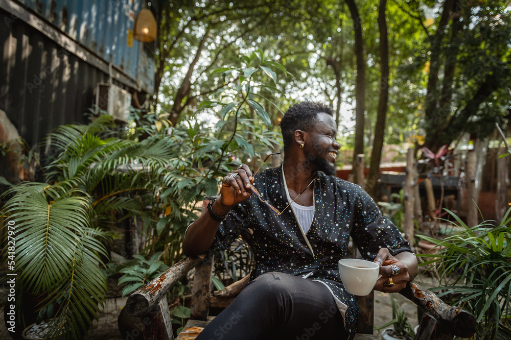 black man holding a tea cup and smiling Stock Photo | Adobe Stock