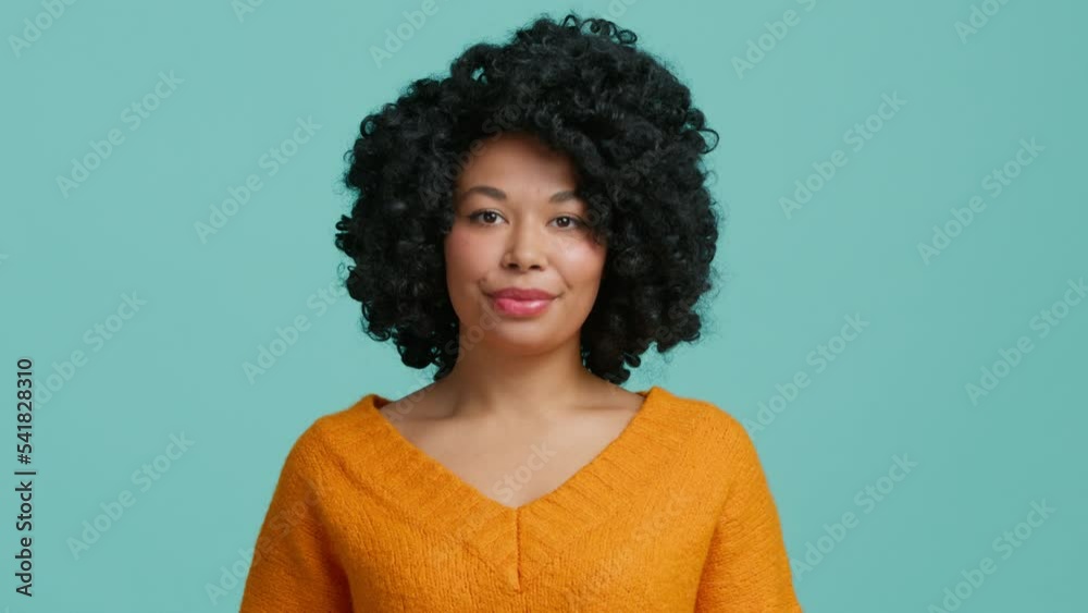 Positively smiling African American model agrees to offer. Female with ...