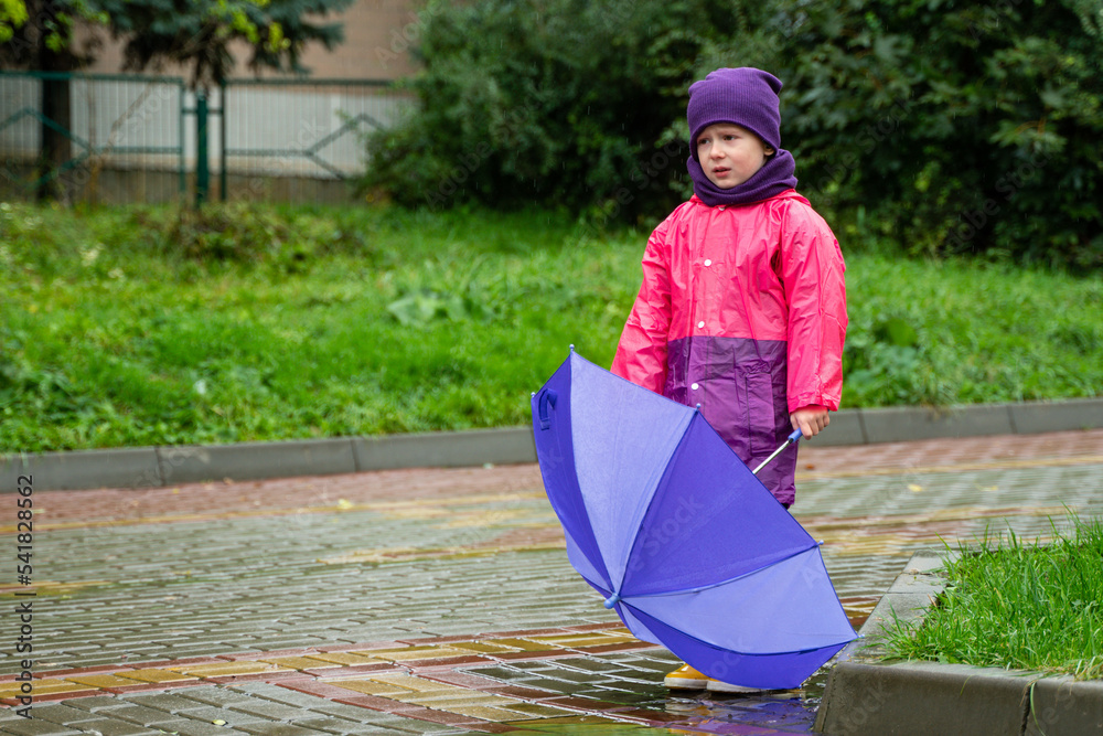 Child playing in autumn rain. Kid with umbrella. Outdoor fun for kids ...