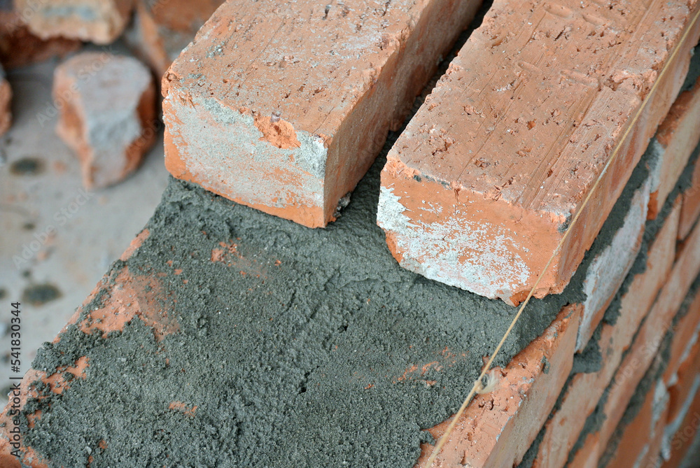 Clay brick arranged to form brick wall. Stock Photo | Adobe Stock