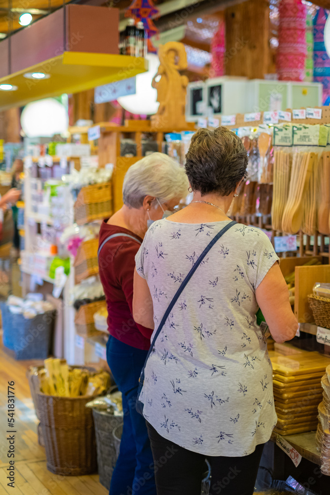 People shopping in the shopping centre. Two elderly woman shopping ...