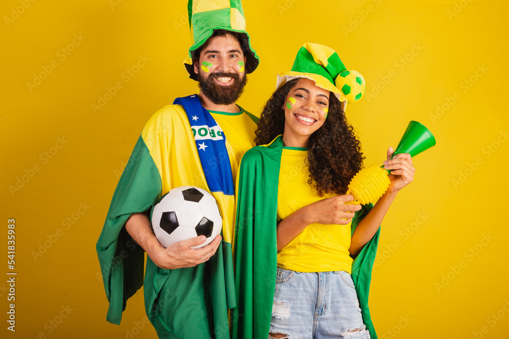 couple of brazil soccer supporters, dressed in the colors of the nation ...