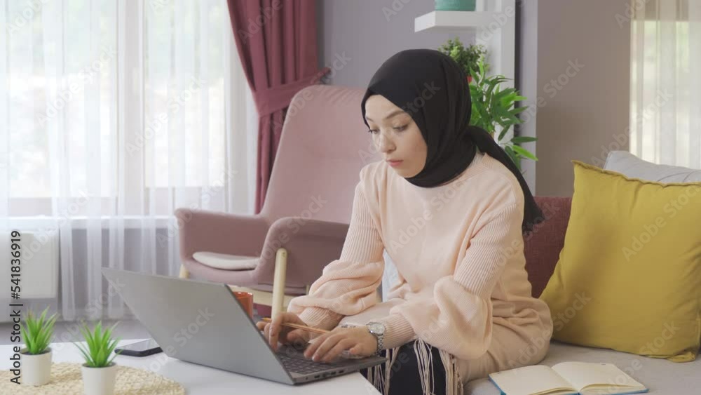 Student young muslim girl working on laptop at home. Muslim teenage ...