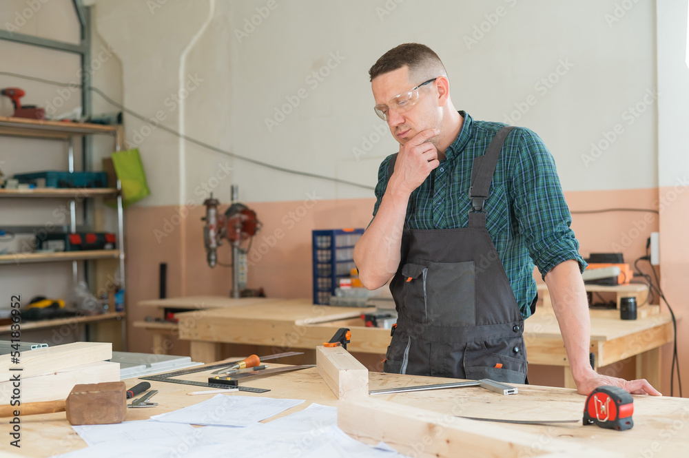 Portrait of a handsome male carpenter in the workshop. Stock Photo ...