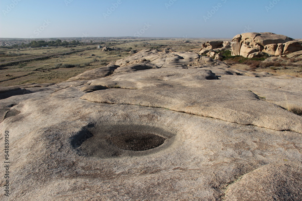 Gray volcanic stone plateau in the Bektau-Ata tract with stones, sunny ...