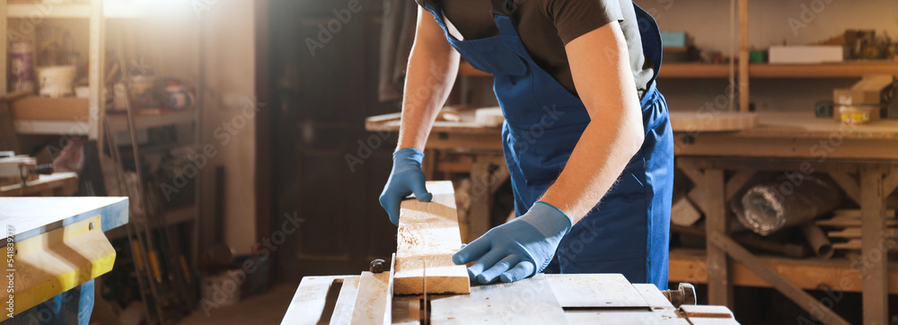 Professional carpenter working with wood in shop, closeup. Banner ...