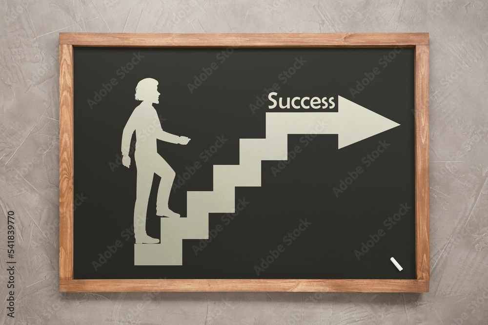 Person going up stairs drawn on chalkboard against grey background ...