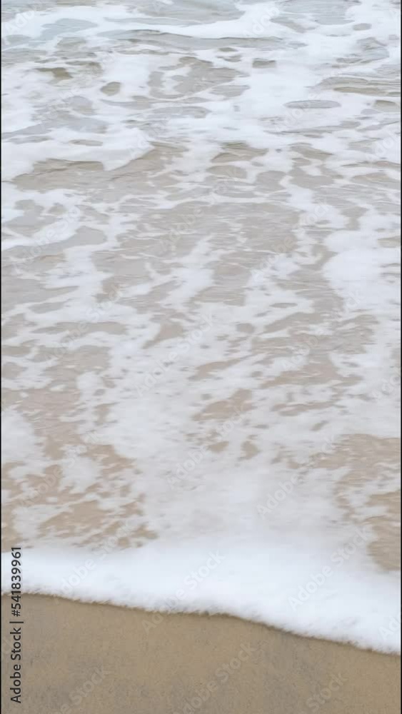 Sand from a Brazilian beach, on a cloudy day, and the movement of waves ...