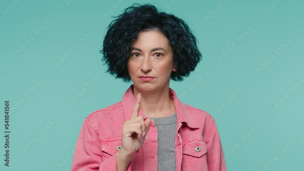 Serious 40s mature woman shakes finger and says no I do not need ...