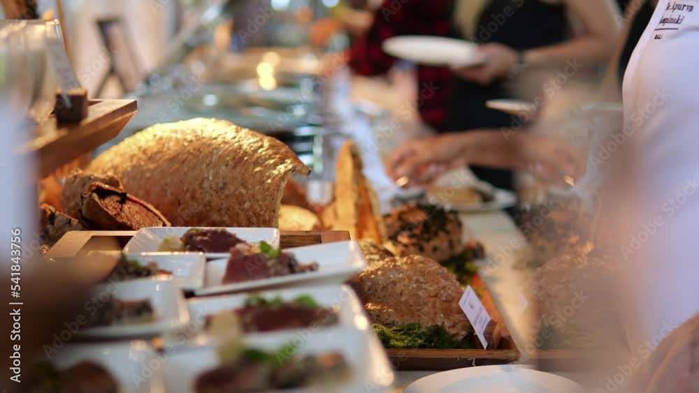 Side view of the buffet table in the hotel. Guests of the hotel came to ...