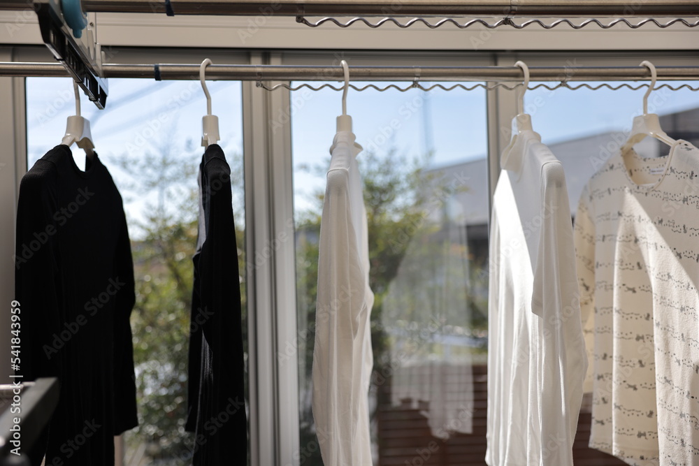 Laundry drying.Sheet hanging on clothesline in front of blue sky and ...