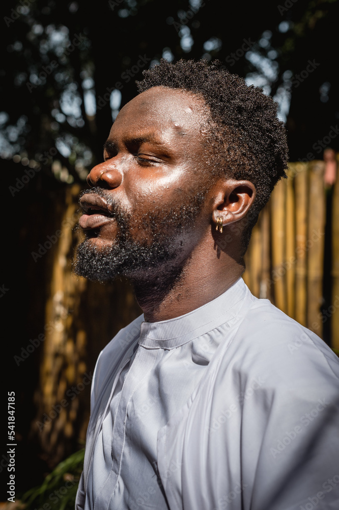 closeup of a black man basking in the sun Stock 写真 | Adobe Stock