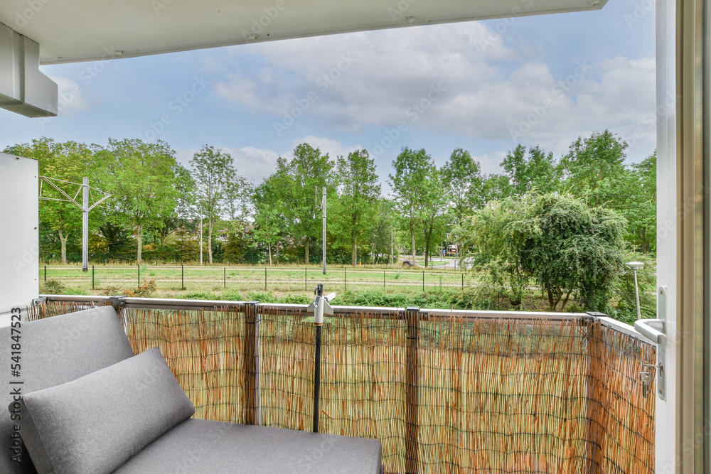 Sitting area in balcony with comfortable furniture around beautiful ...