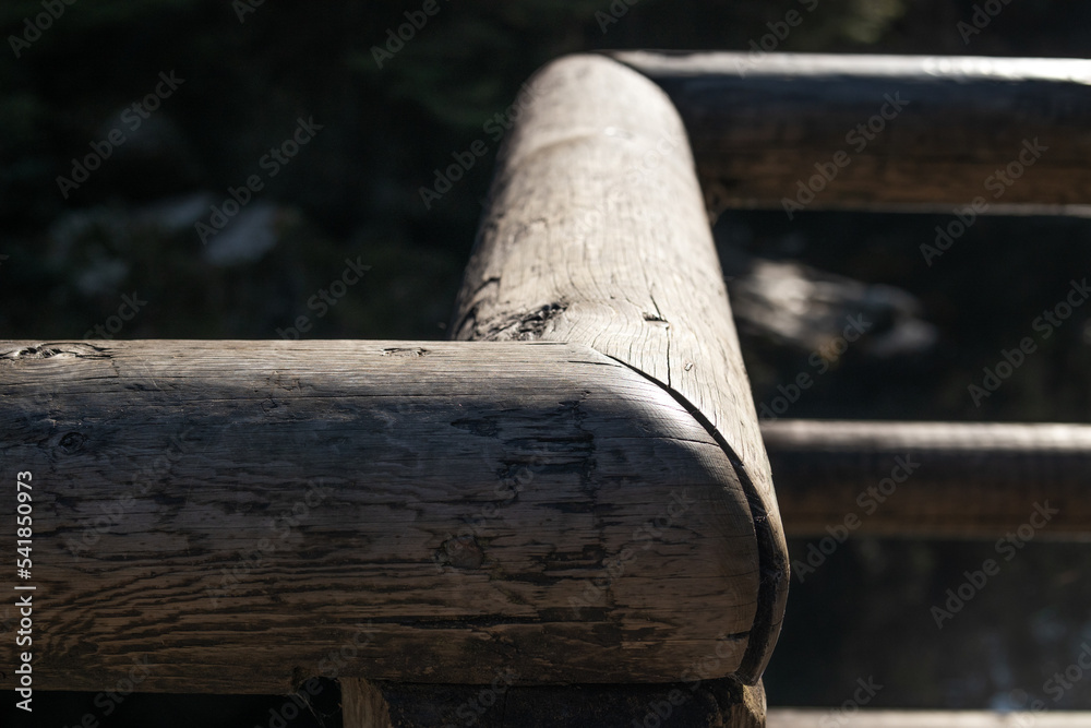 Rustic wood fence corner with heavy light and shadow. Park fence or ...