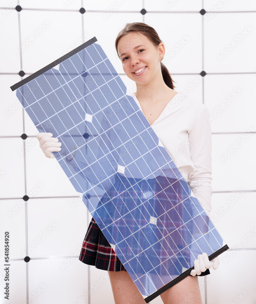 young woman dressed in a short skirt with a transparent solar panel in ...