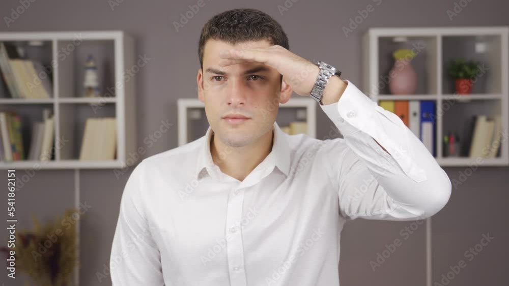 The man is looking around and searching. Young man looking around and ...