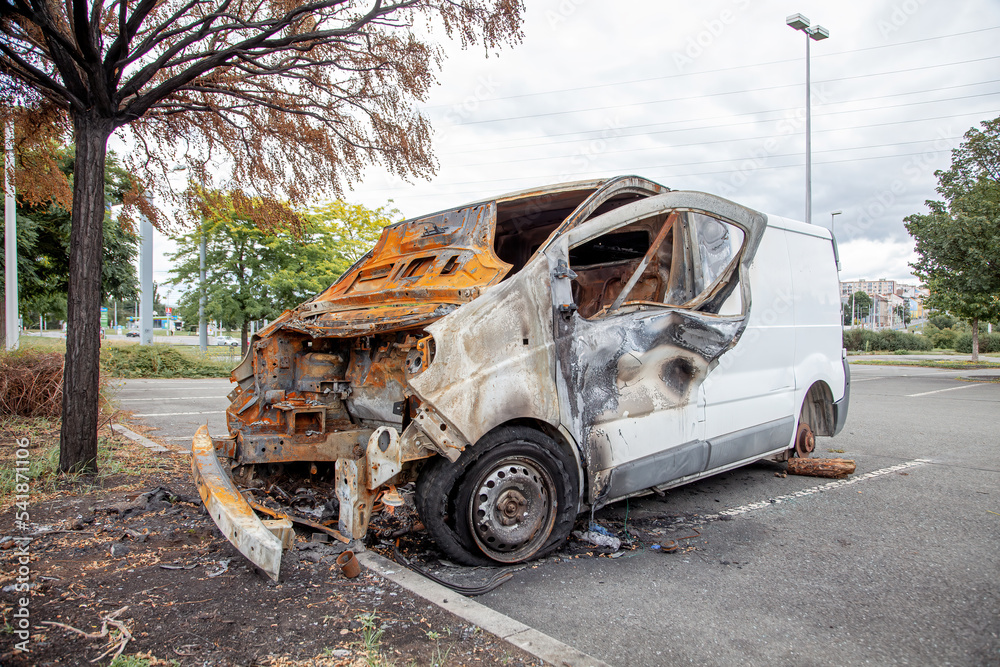 Minibus after a fire, burnt body and interior of the car. Burnt rusty ...