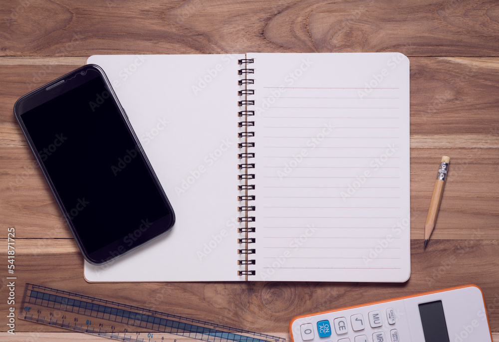 Written in notebook on office desk with office accessories, business ...