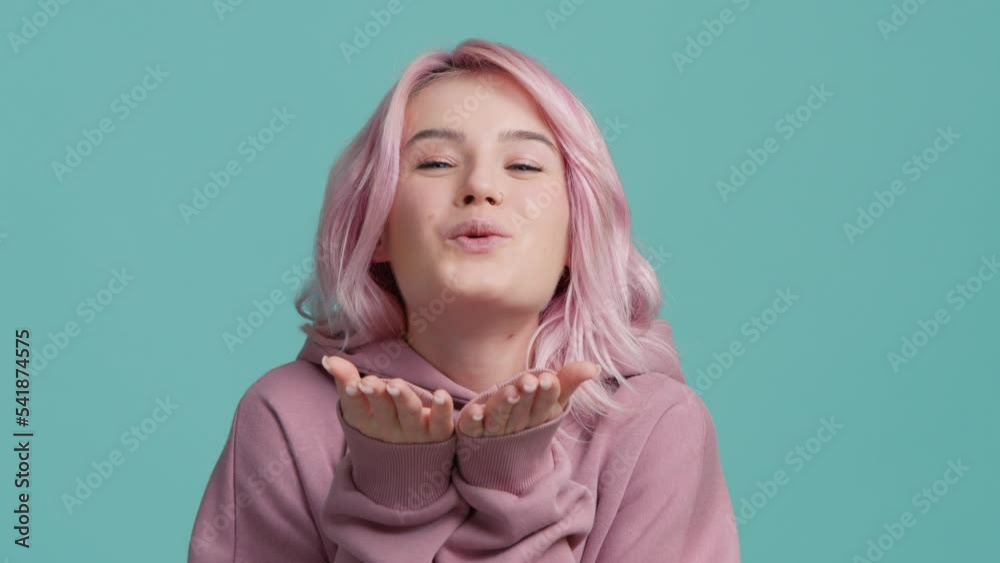 Cute smiling lady with pastel pink hairstyle in trendy hoodie send air ...