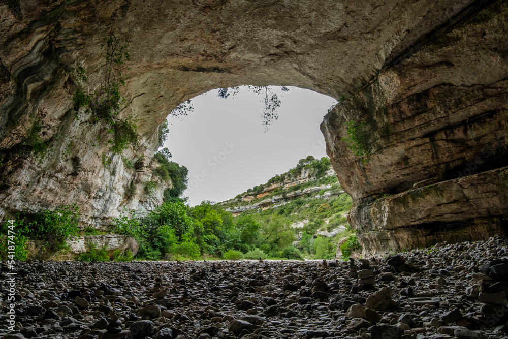 Inside the "Grand Pont Naturel", a cave carved by the Cesse river near ...