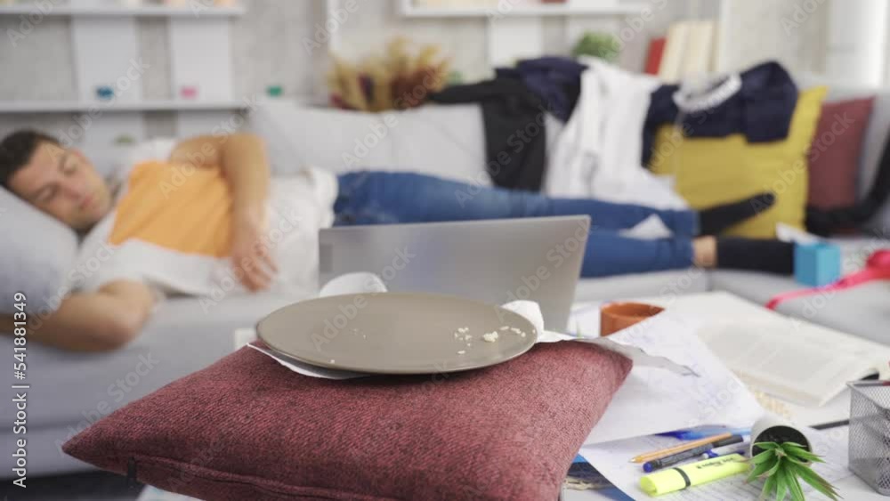 Messy house. Young man in dirty and messy house. Messy young man ...