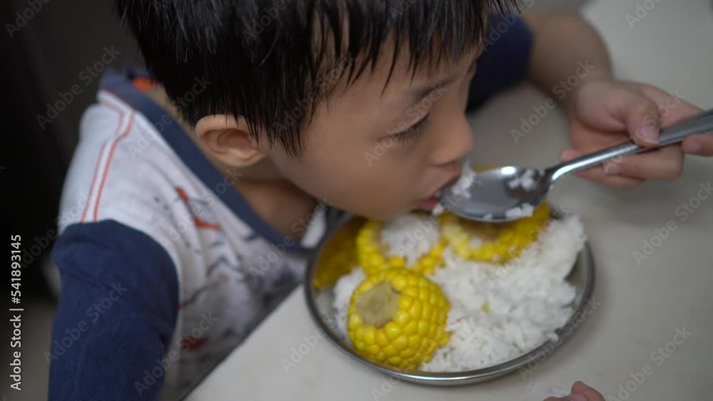 Select focus the face of kid eat the rice with corn Stock Video | Adobe ...