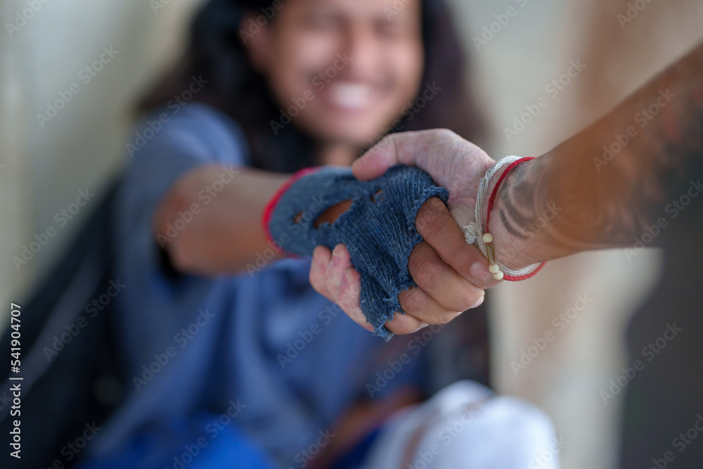 Close-up handshake homeless man on walkway street in the city ...