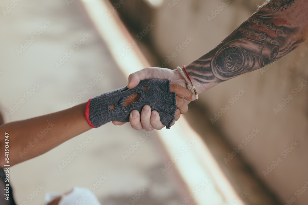 Photo & Art Print Close-up handshake homeless man on walkway street in ...