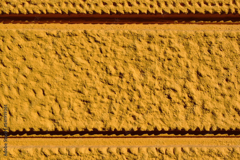 yellow stucco exterior elevation detail with rough steepled texture ...