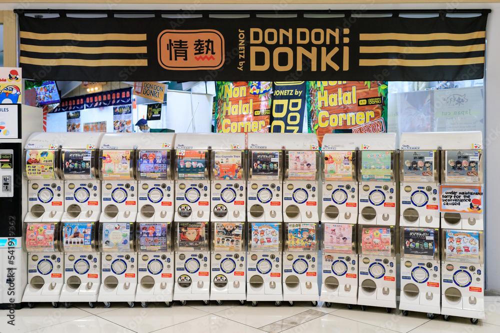 Capsule toy machines of Gachapon, a trademark of Bandai, in front of ...