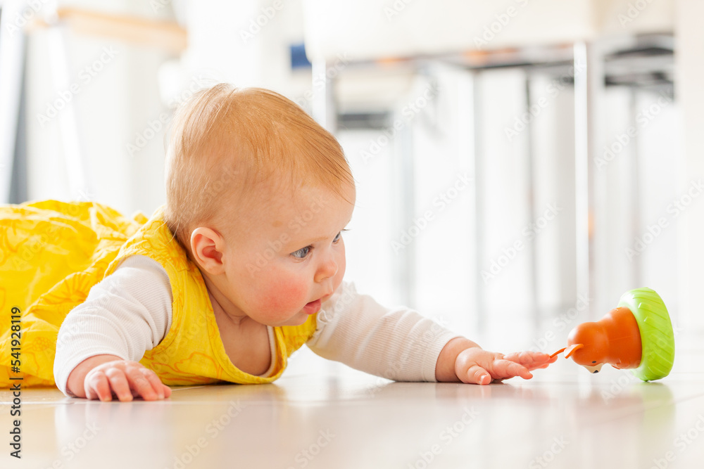 young australian baby girl in yellow dress playing with kangaroo toy on ...