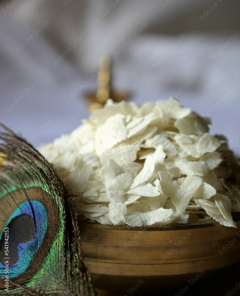 Close-up of raw Poha/Beaten rice flakes/Flattened rice and peacock ...