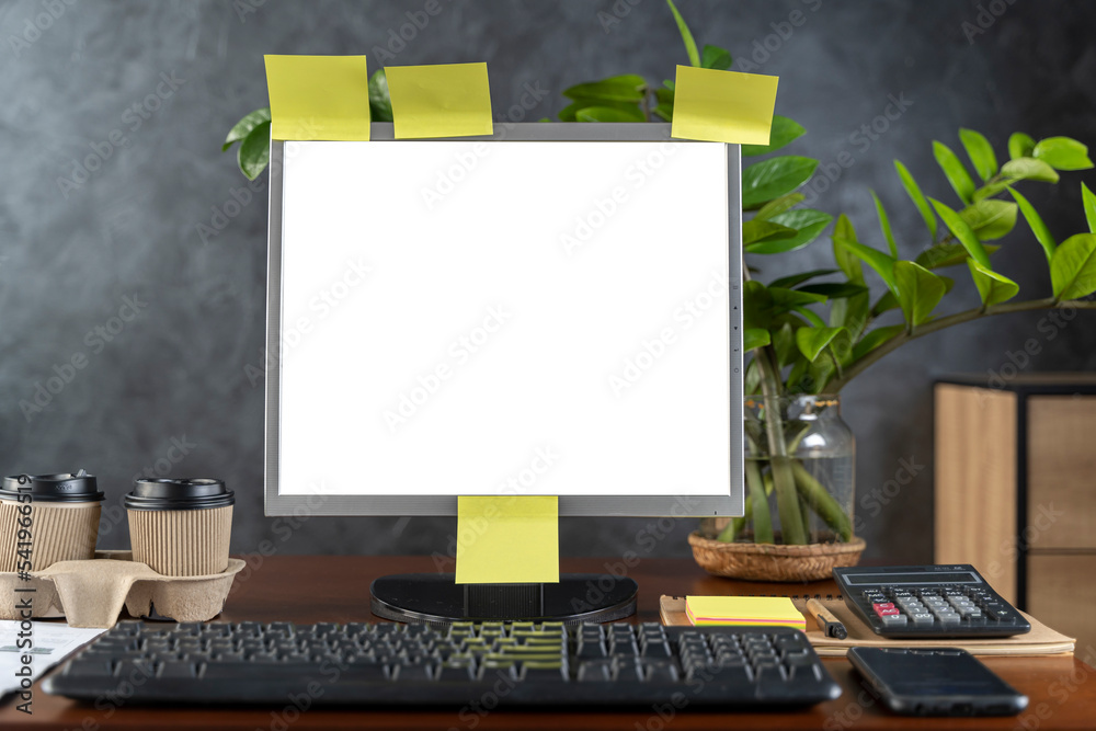 Computer monitor with white blank screen on the business desk with ...