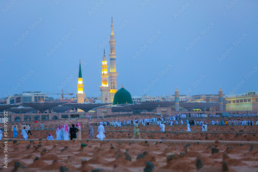 Muslim pilgrims visiting the beautiful Nabawi Mosque, and green dome of ...