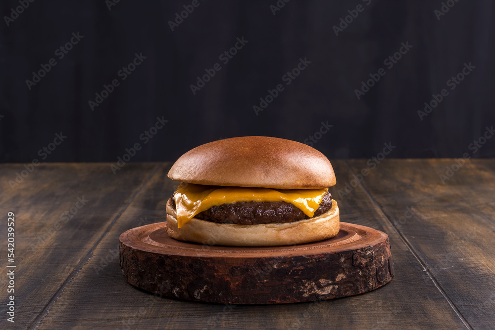delicious fast food cheeseburger on a rustic wooden table Stock Photo ...