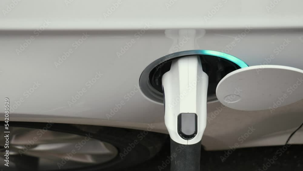 Electric car charging top view. Electric vehicle charging port plugging ...