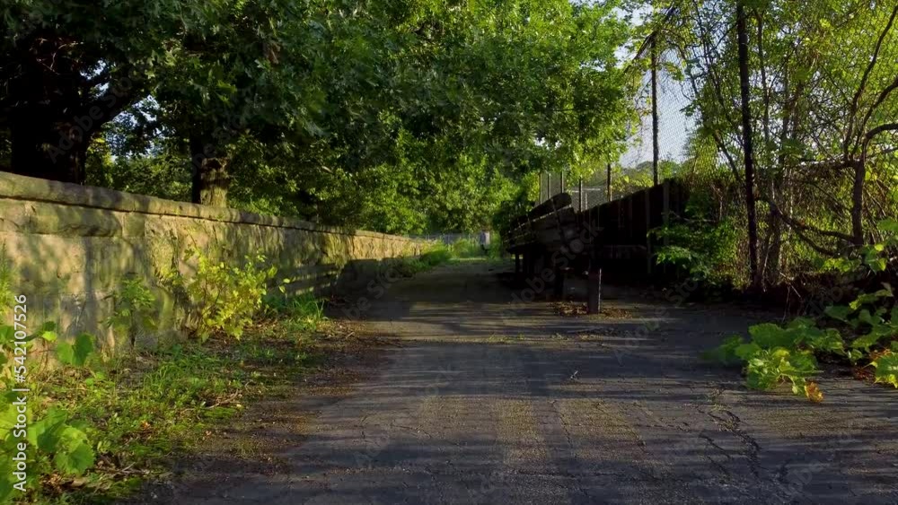 Low drone flythrough of abandoned and overgrown park and benches Stock ...