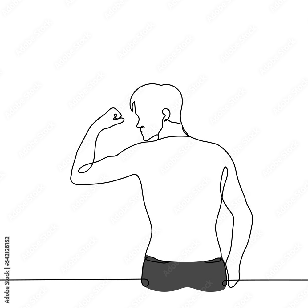 muscular shirtless man stands with his back to the viewer and ...