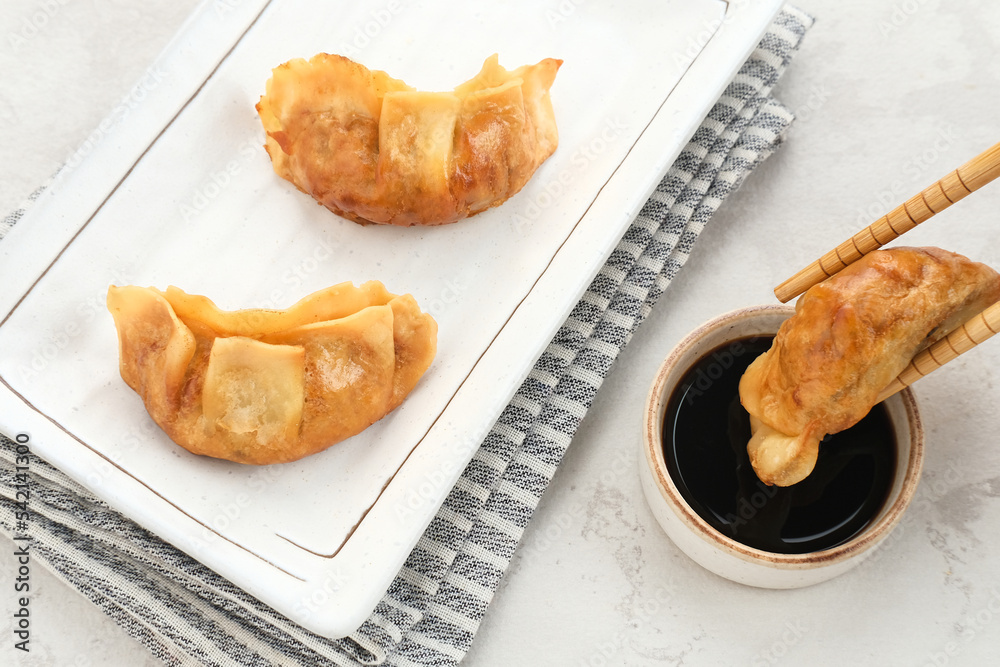 Gyoza, deep fried dumpling with juicy chicken and cabbage. Served in ...